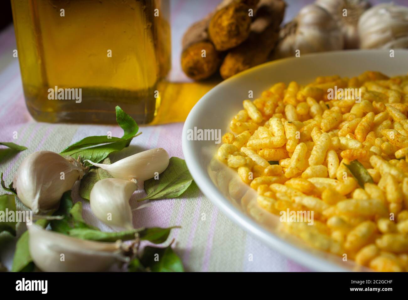 Spicy puffed rice (also known as muri, porri) in a plate with ginger ...