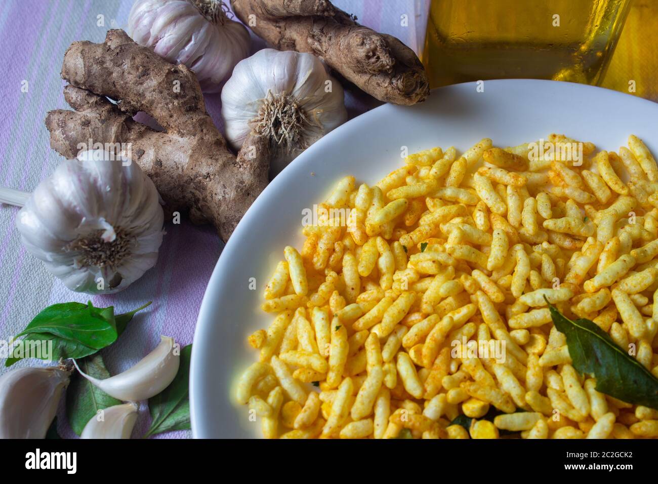 Spicy puffed rice (also known as muri, porri) in a plate with ginger ...