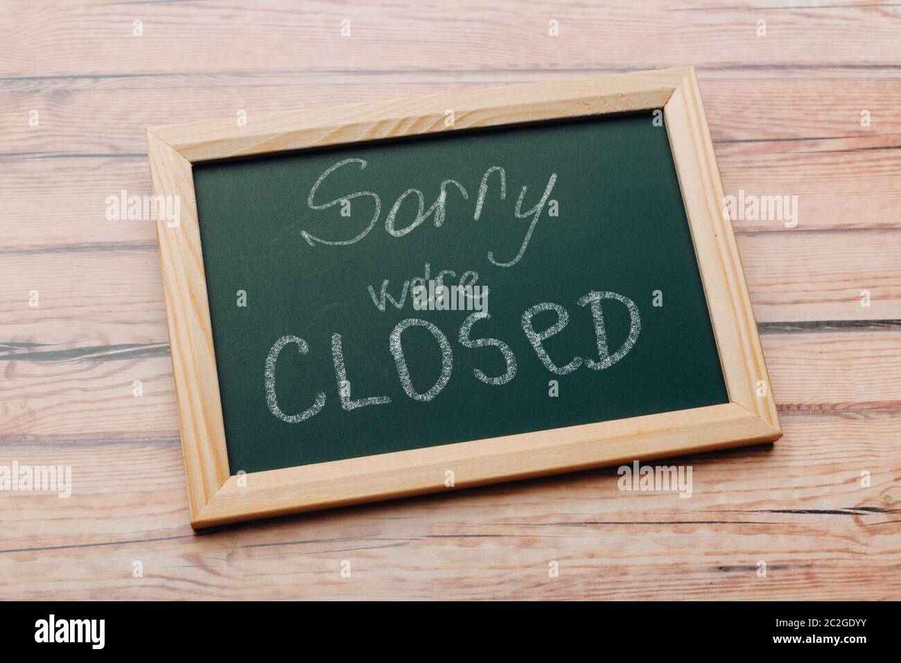 Sign "Sorry, we are closed" on a chalk board with English inscriptions ...