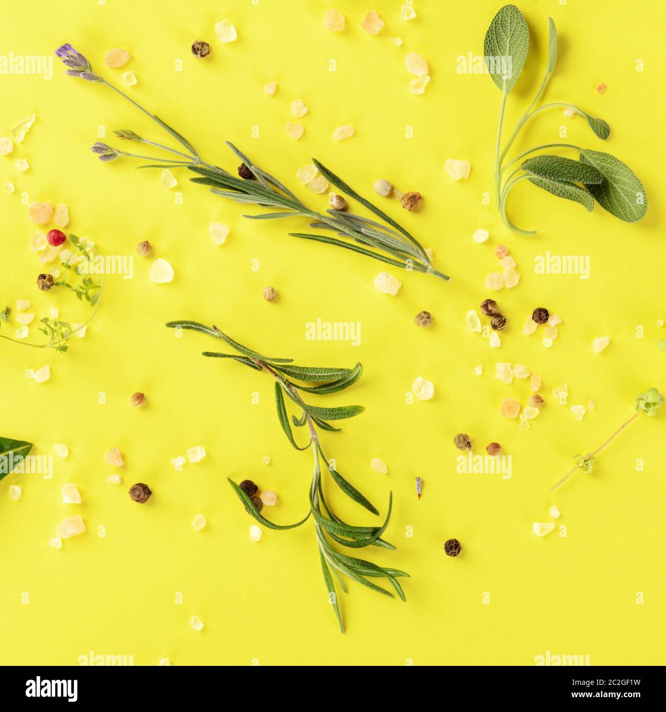 Herbs and spices on a yellow background, an abstract flat lay cooking ...