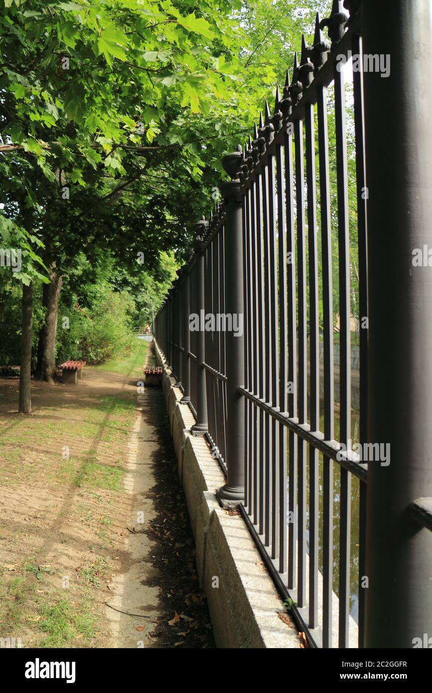 path along high steel fence going straight into the distance Stock ...