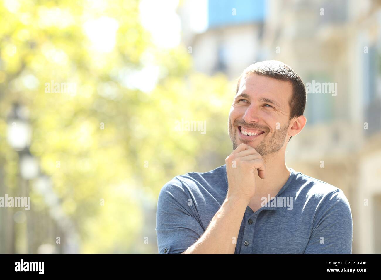 Front view portrait of a happy adult man thinking looking at side ...