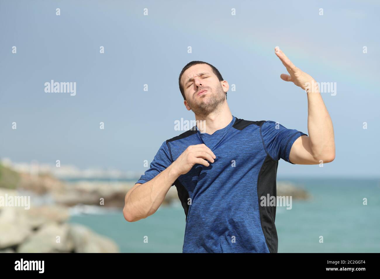 Stressed runner suffering heat stroke complaining and fanning with his ...