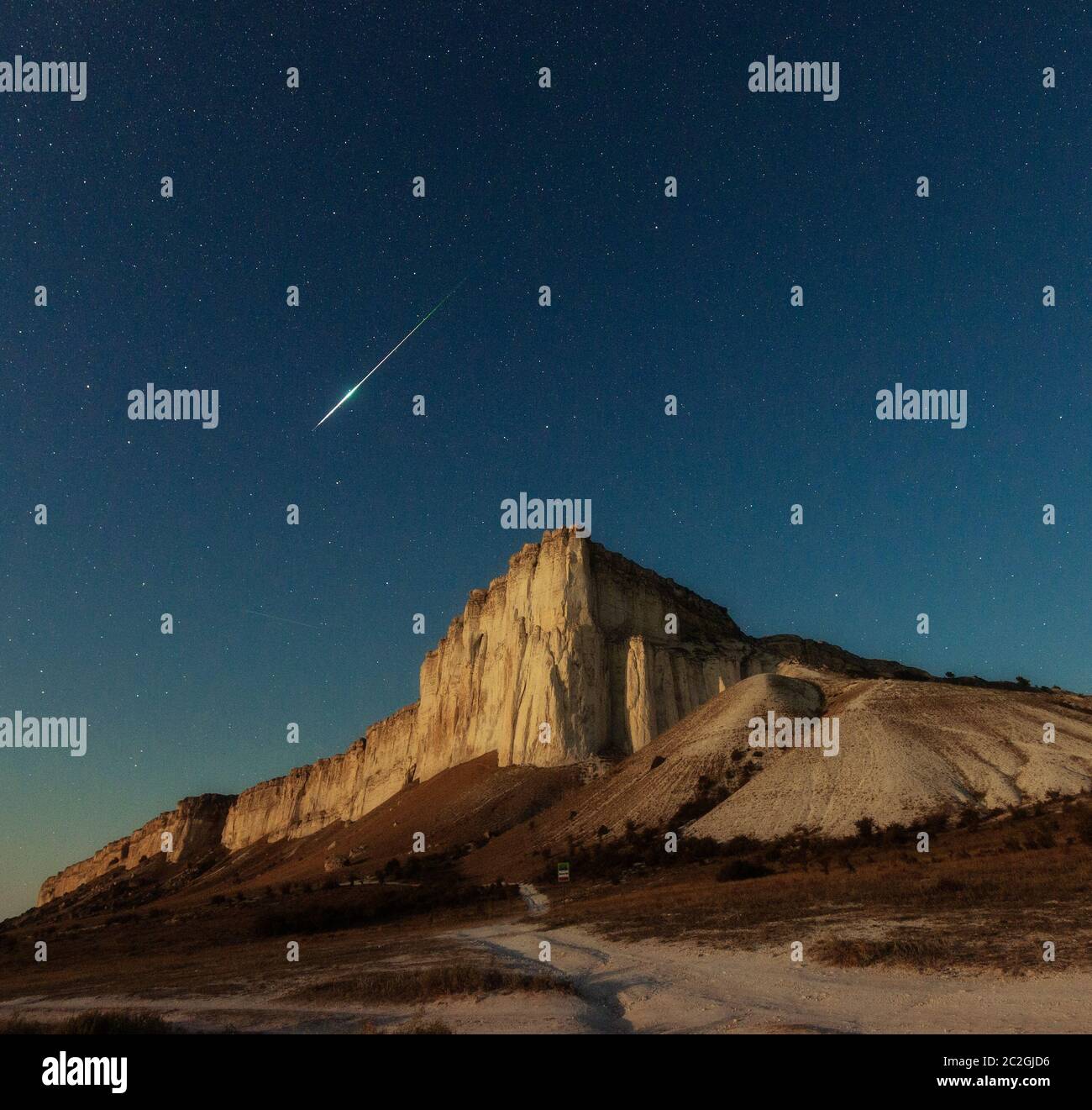 Night star sky and meteor over rock Stock Photo - Alamy
