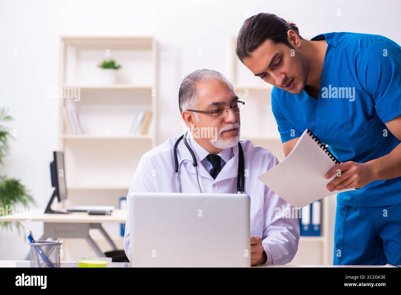 Two male doctors working in the modern clinic Stock Photo - Alamy