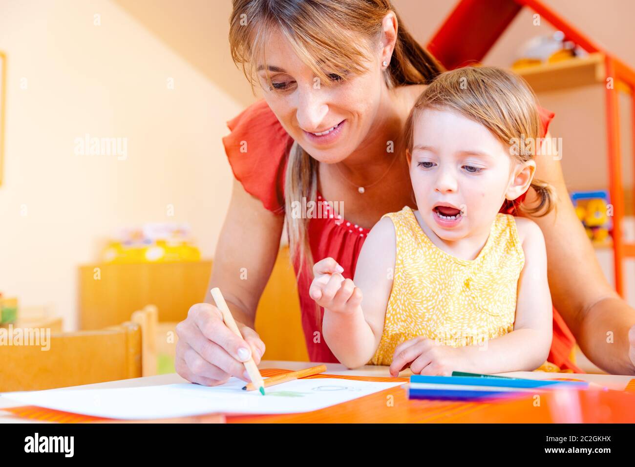 Children and play school teacher drawing together with pencils Stock ...