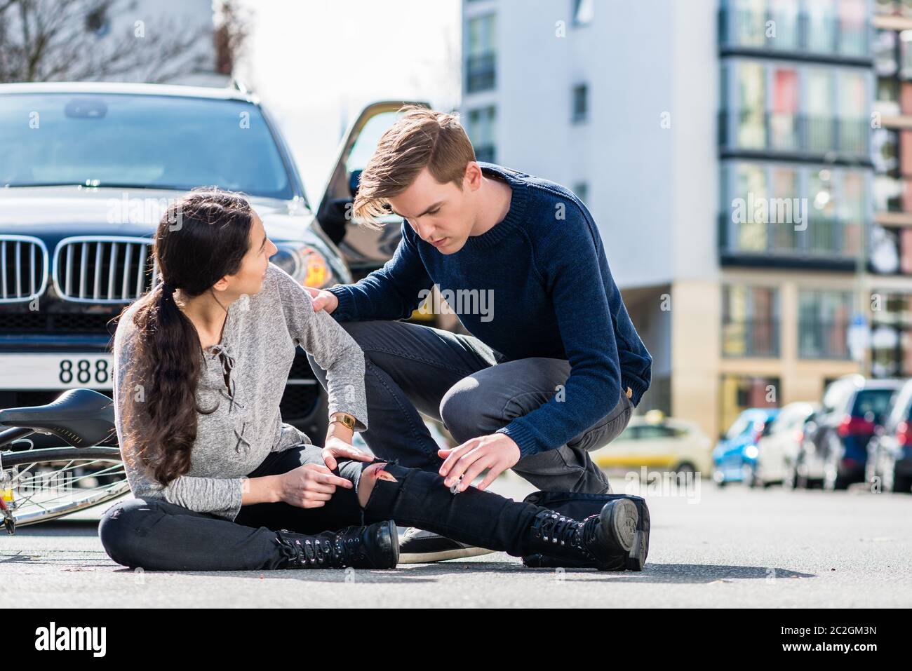 Young male driver using a sterile adhesive bandage from his first aid ...