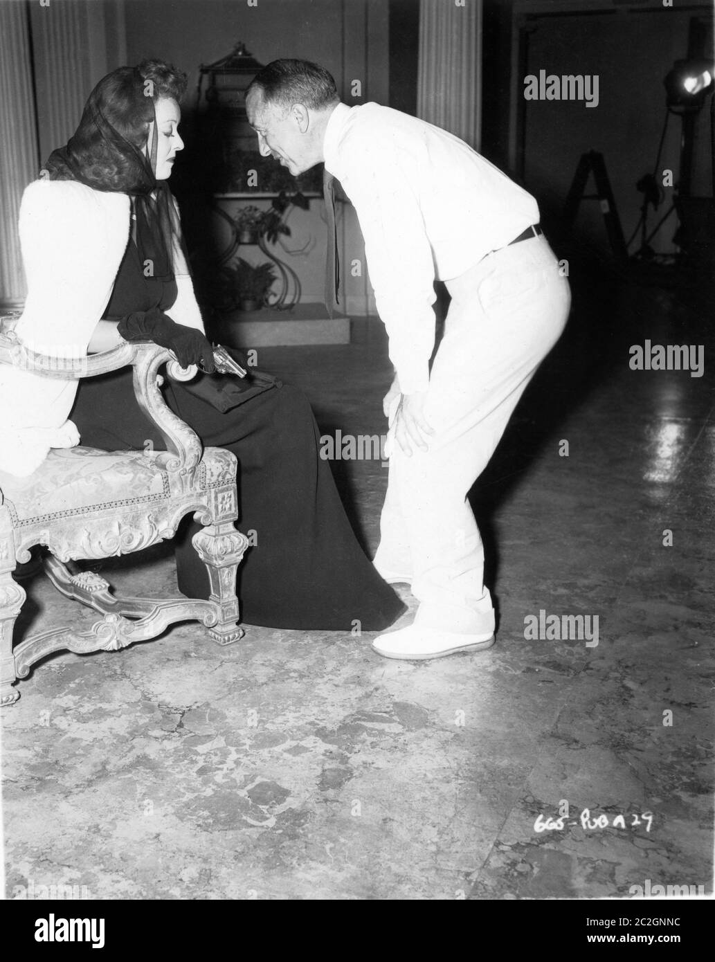 BETTE DAVIS and Producer HENRY BLANKE on set candid during filming of ...