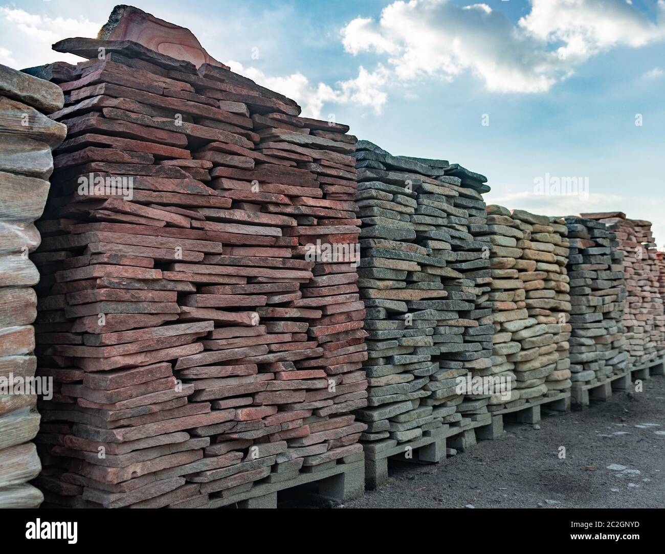 Pallets with natural facing stone and cobblestones Stock Photo - Alamy