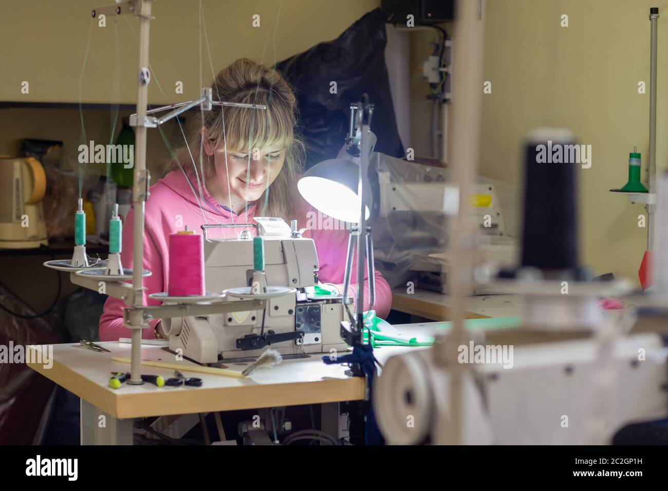 Garment worker works for an industrial sewing machine Stock Photo - Alamy