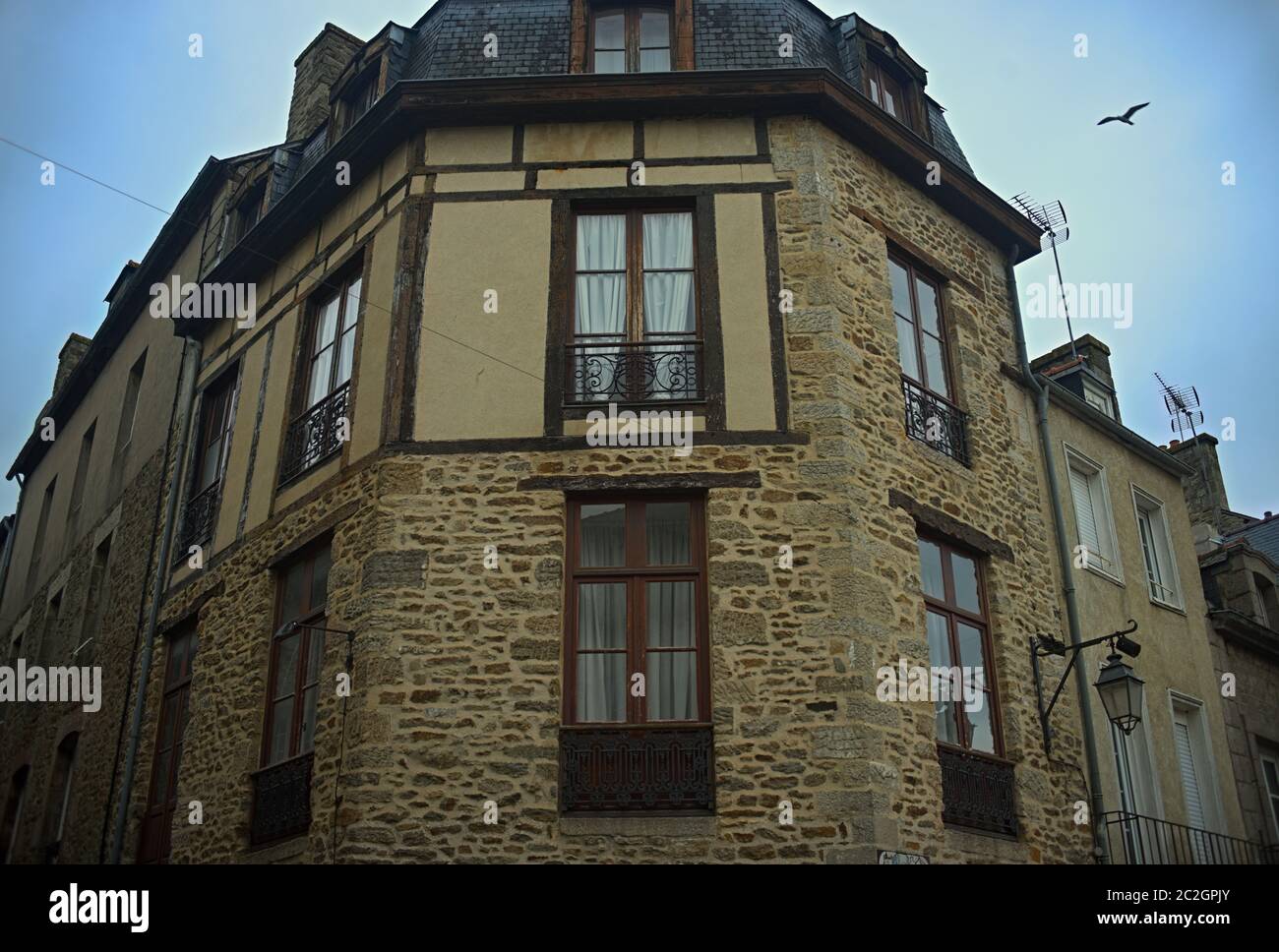 Old traditional French stone corner building with wooden windows Stock ...