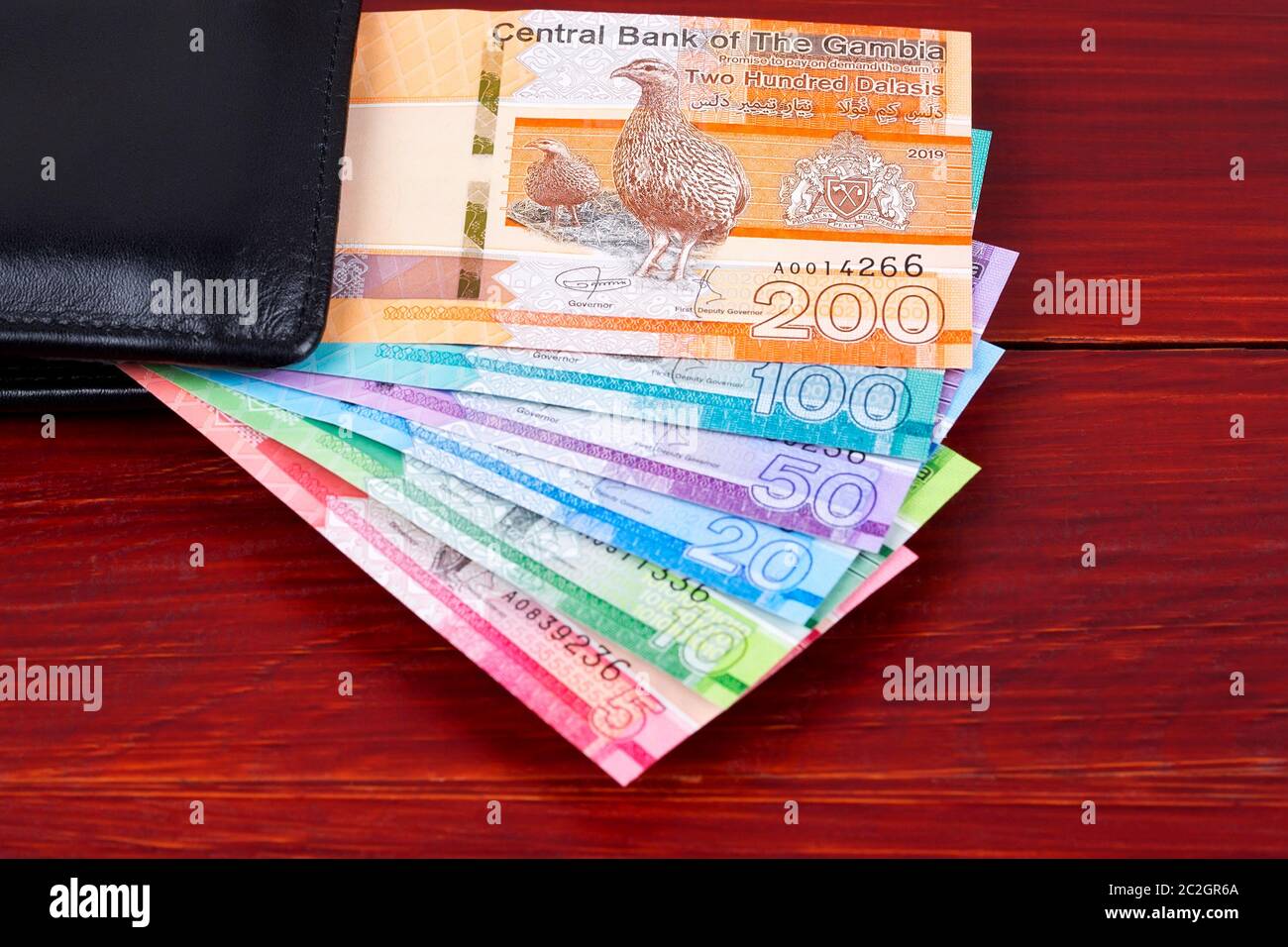 Gambian Dalasi in the black wallet Stock Photo - Alamy