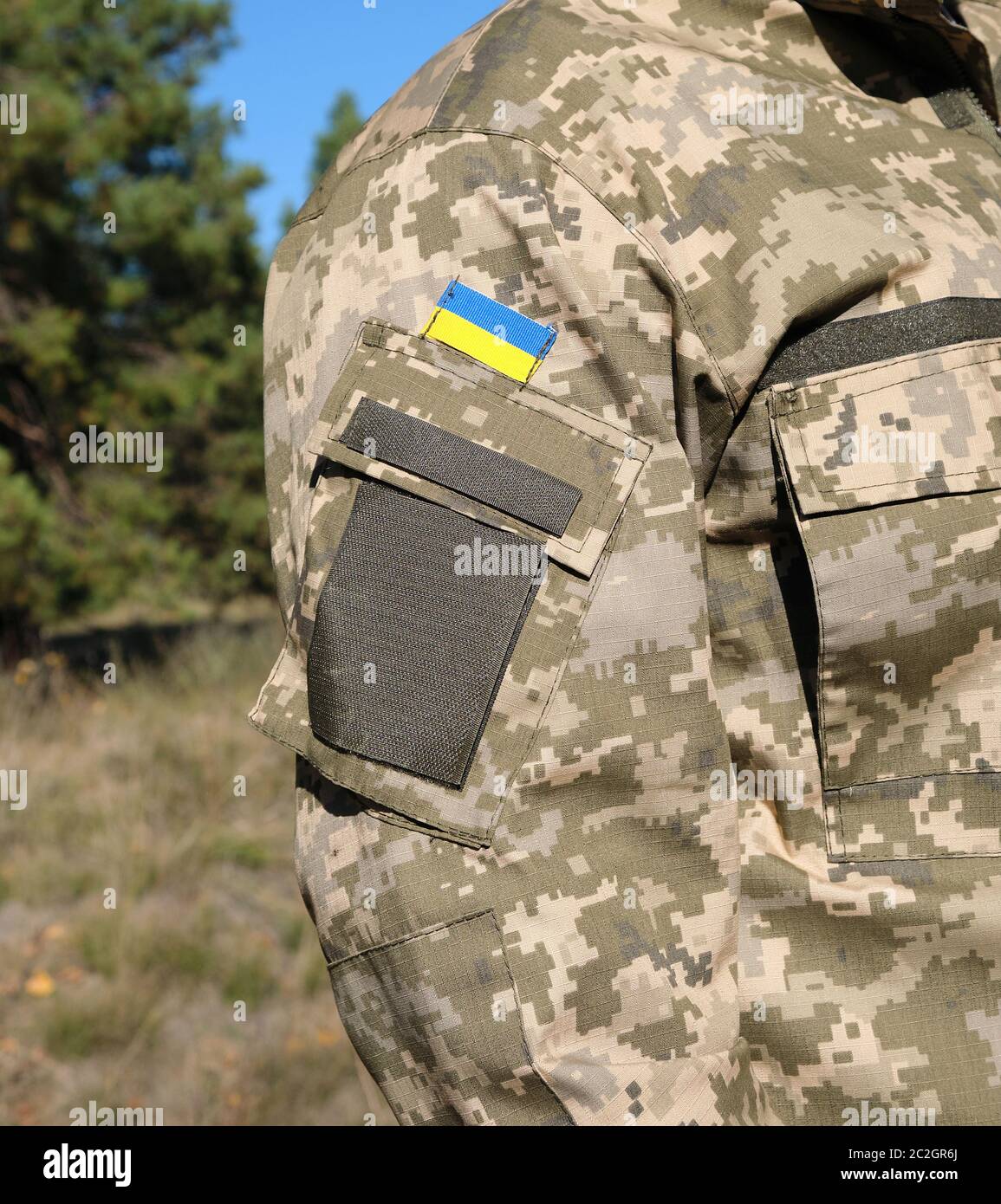 fragment of the hand of a Ukrainian soldier in military camouflage ...