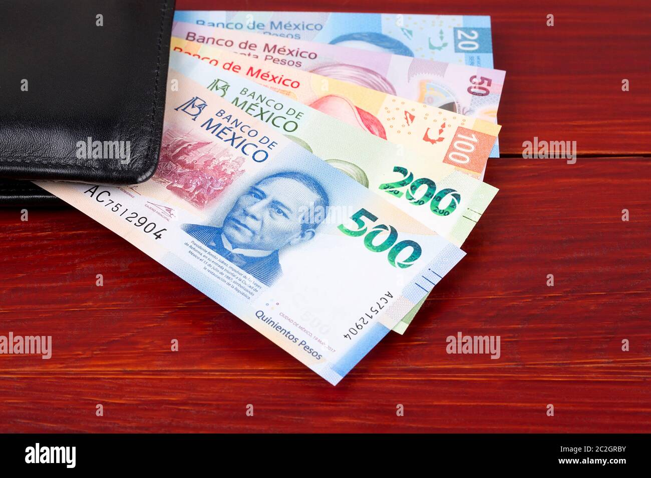 Mexican peso in the black wallet Stock Photo - Alamy