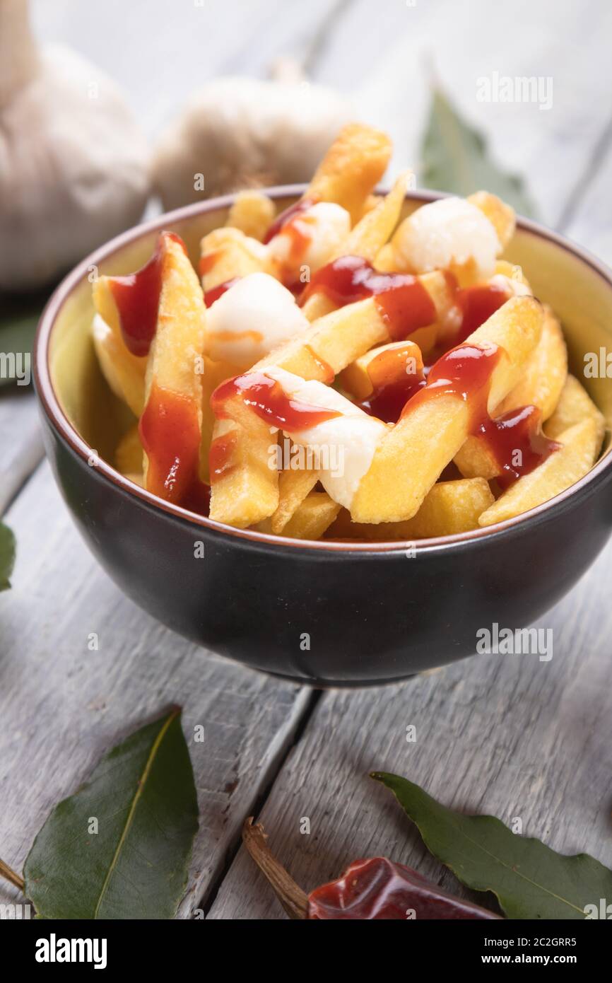 Canadian poutine, fried potato chips with cheese and gravy or sauce ...