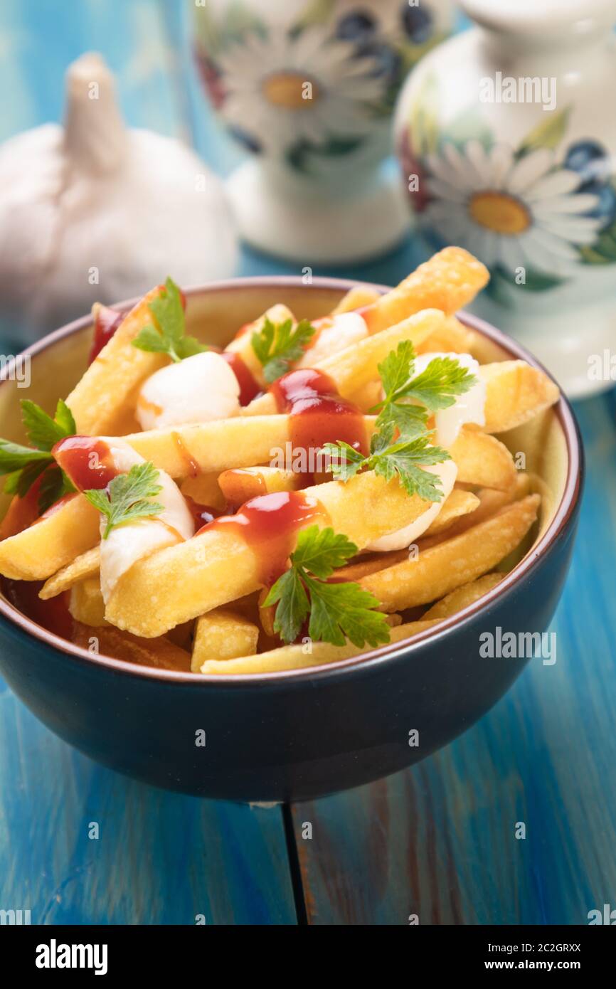 Canadian poutine, fried potato chips with cheese and gravy or sauce ...