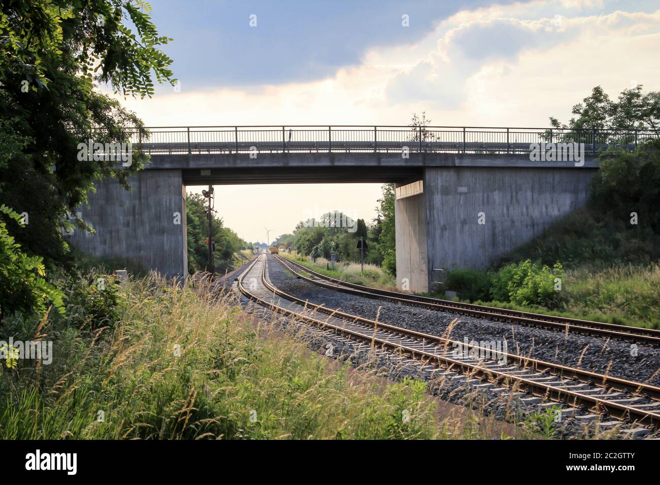A bridge leads over railroad tracks Stock Photo - Alamy