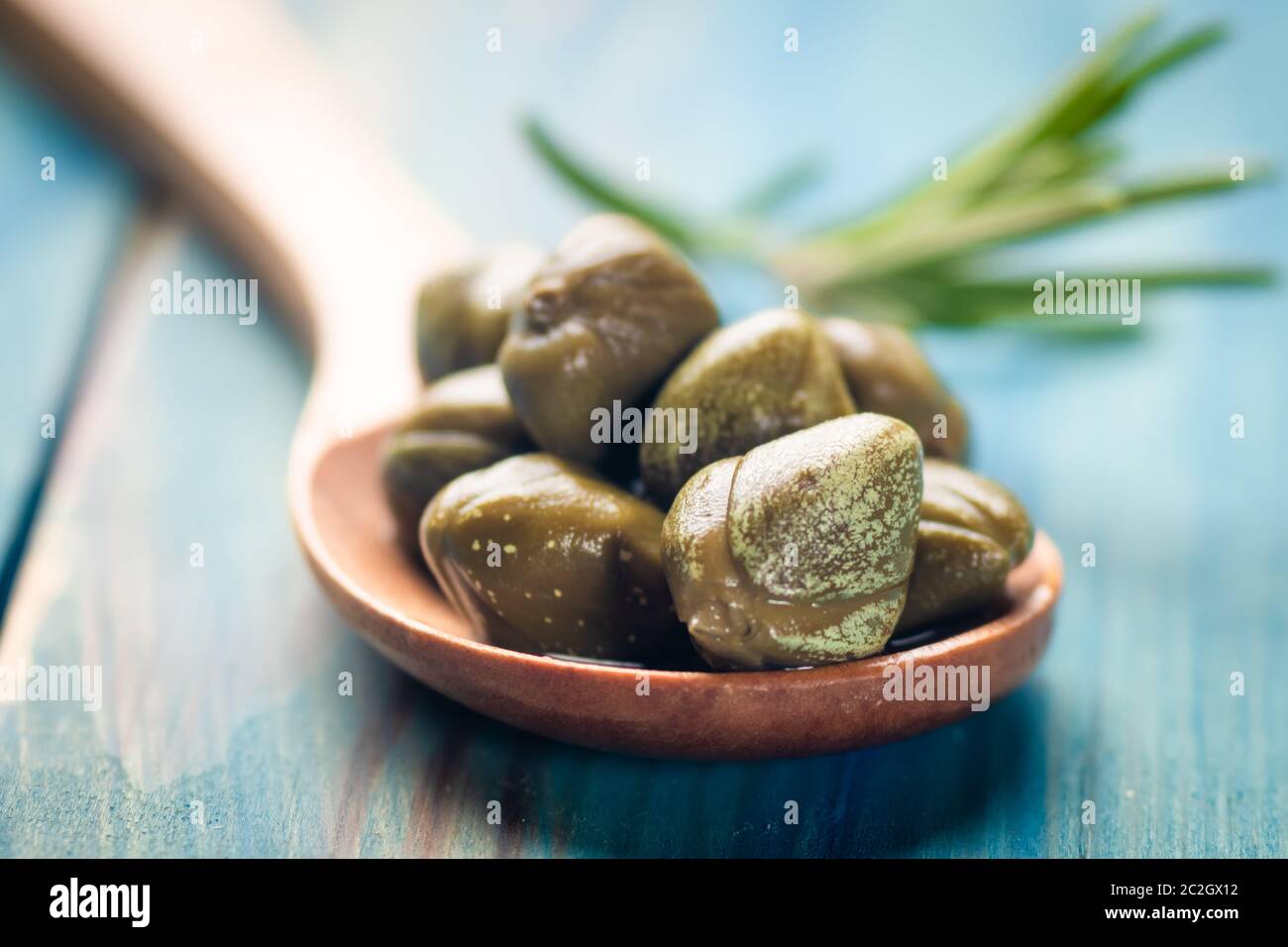 Pickled or marinated green capers close-up, selective focus Stock Photo ...