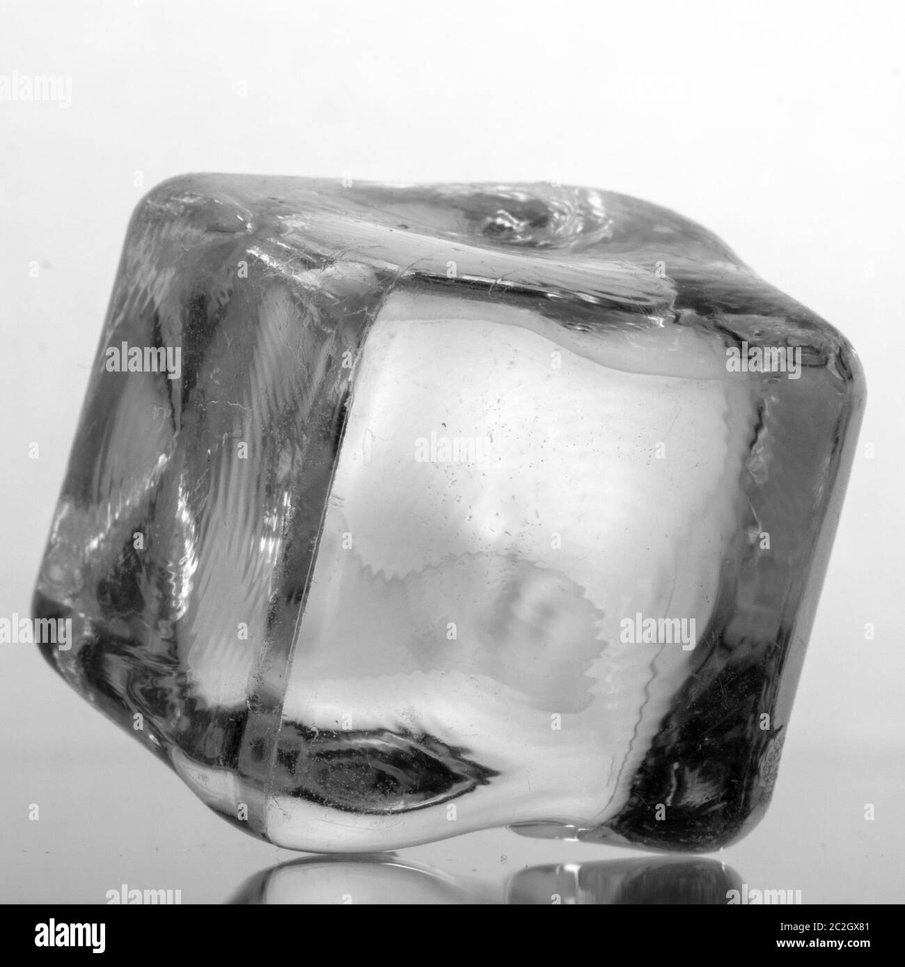 One cube of ice on a white background Stock Photo - Alamy
