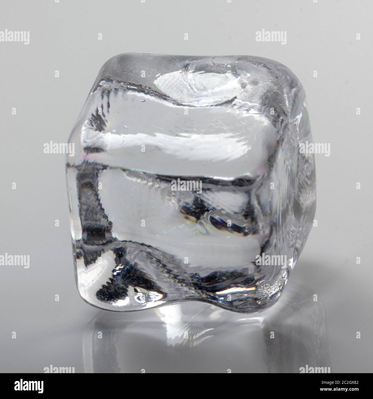 One cube of ice on a white background Stock Photo - Alamy