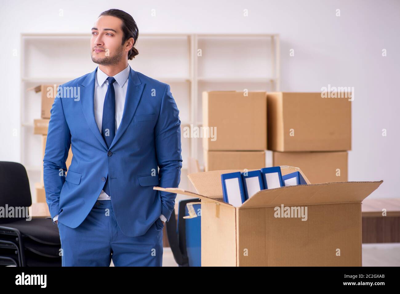Young employee in relocation concept Stock Photo - Alamy