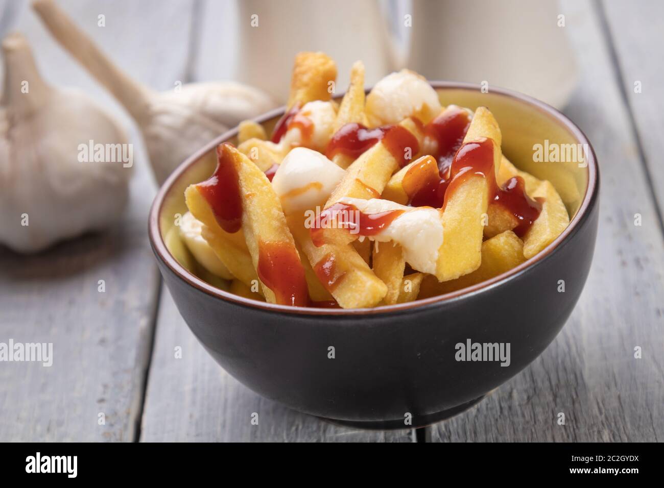 Canadian poutine, fried potato chips with cheese and gravy or sauce ...