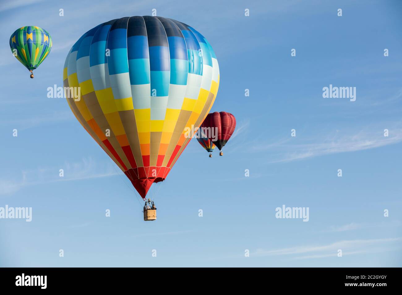 Multi colored hot air balloons on blue sky Stock Photo - Alamy