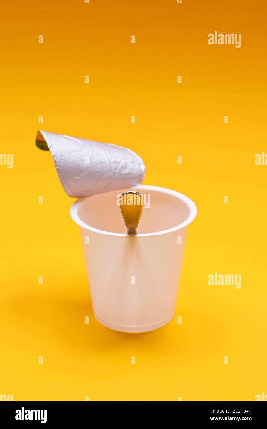 empty clean yogurt cup with spoon on an orange background Stock Photo ...