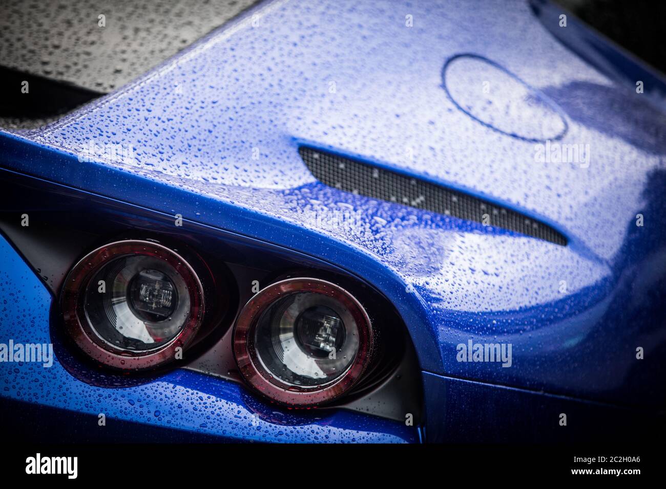 Close up vertical image of the round tail lights of a new sport super car Stock Photo - Alamy