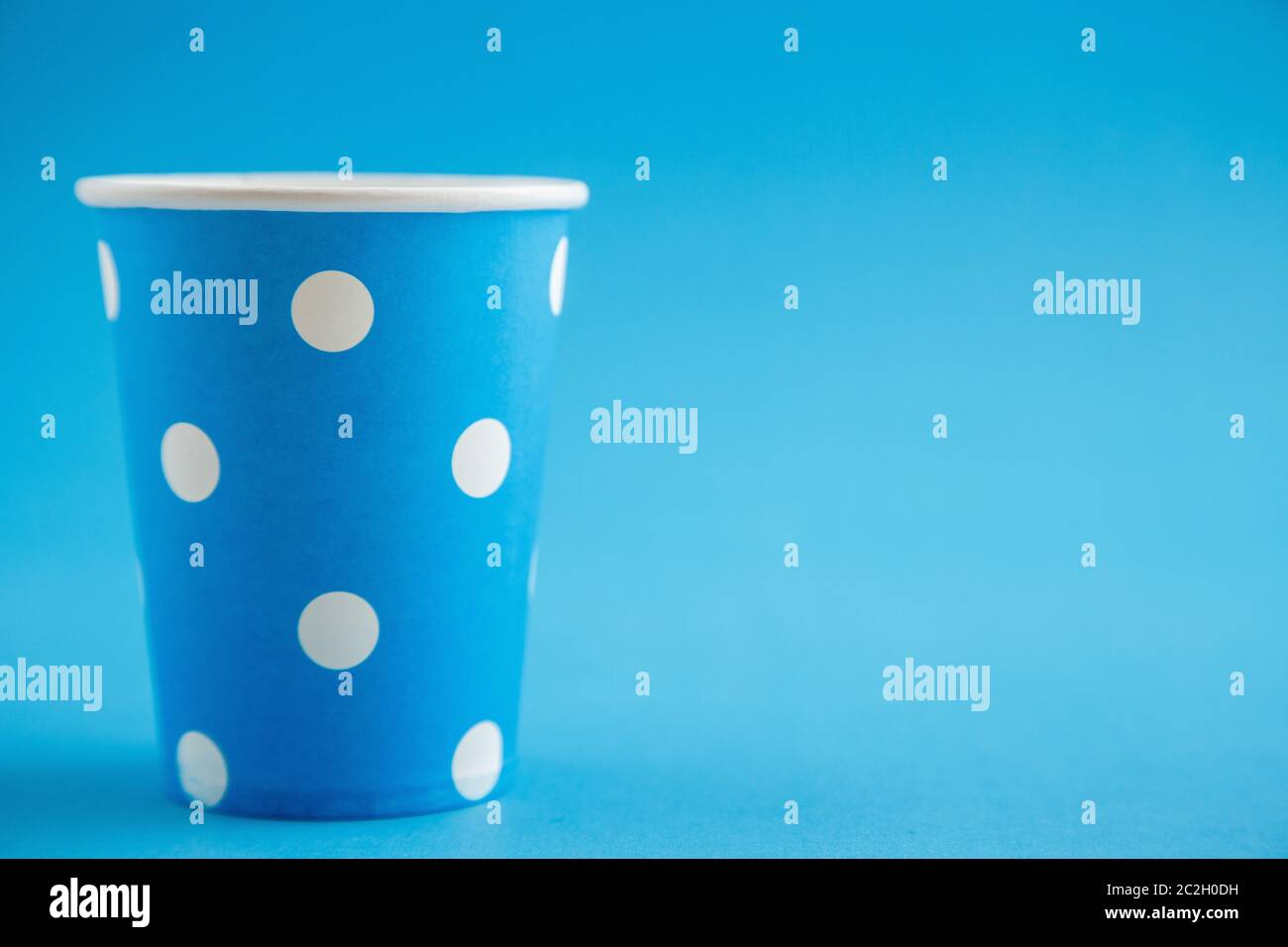 cardboard biodegradable eco-friendly cups on a blue isolated background ...
