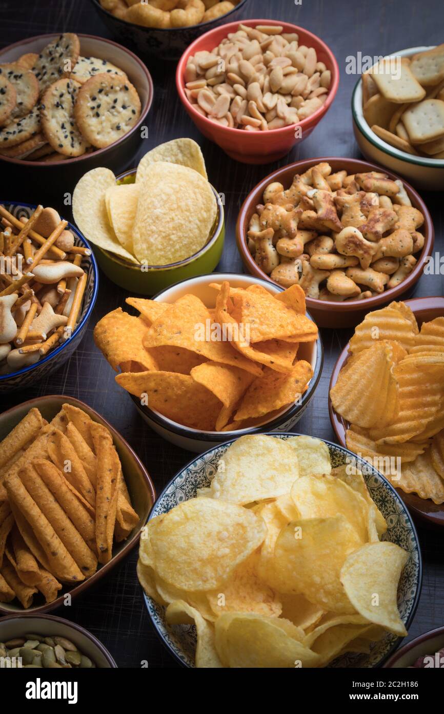 Salty snacks served as party food in ceramic bowls Stock Photo - Alamy