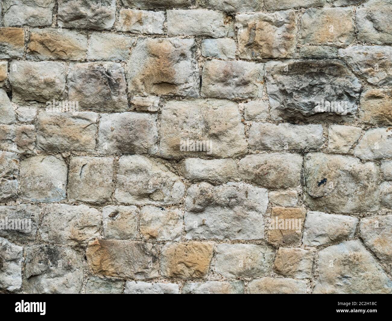 Wall of medieval fortress with mainly white or light colored stones of ...