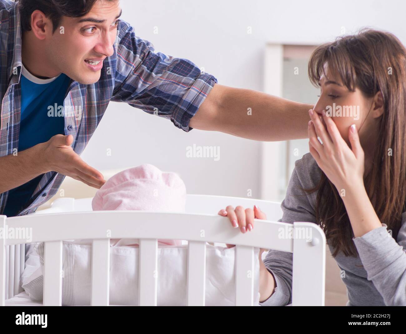 Young dad cannot stand baby crying Stock Photo - Alamy