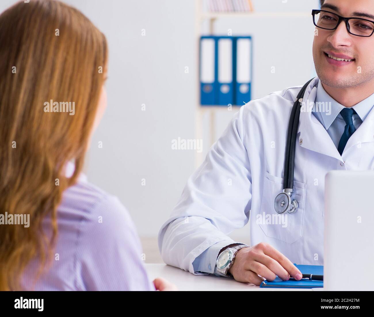 Patient visiting doctor for medical check-up in hospital Stock Photo ...