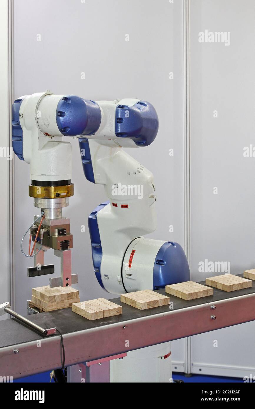 Robotic Arm at Conveyor Belt Production Line in Factory Stock Photo - Alamy