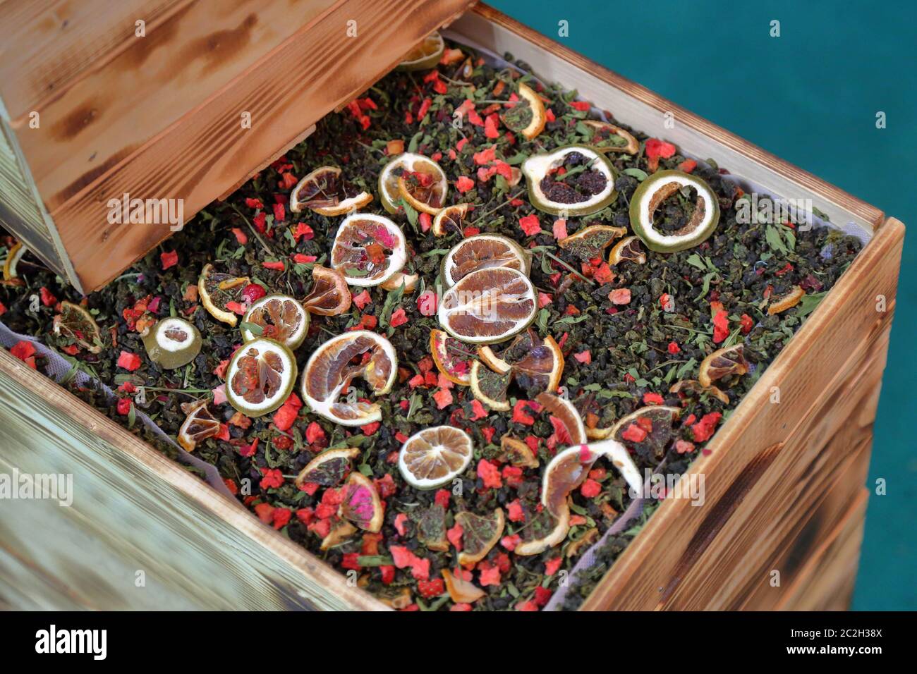 Fruit tea leaves with a mixture of dried berries in large wooden crates ...