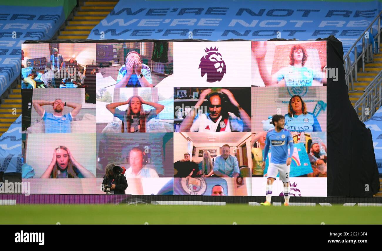 Manchester City fans react on the big screen during the Premier League ...