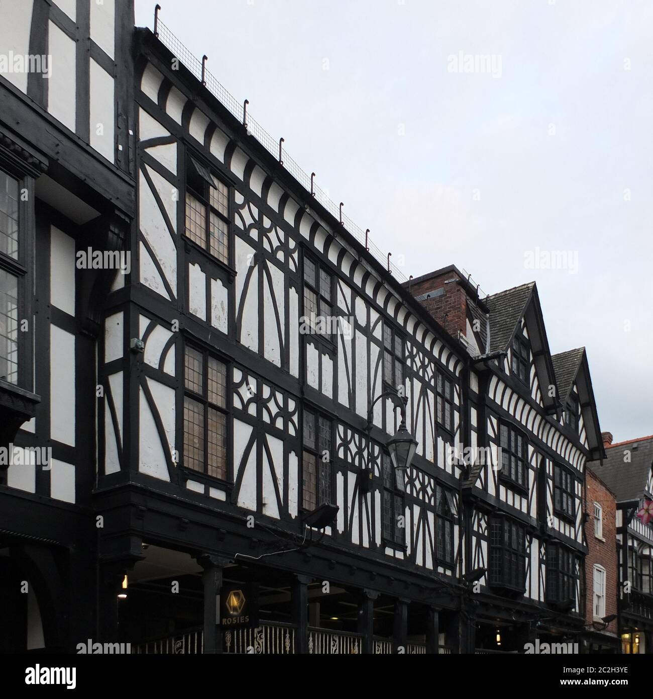 a row of ornate old half timbered gabled buildings in the historic city ...