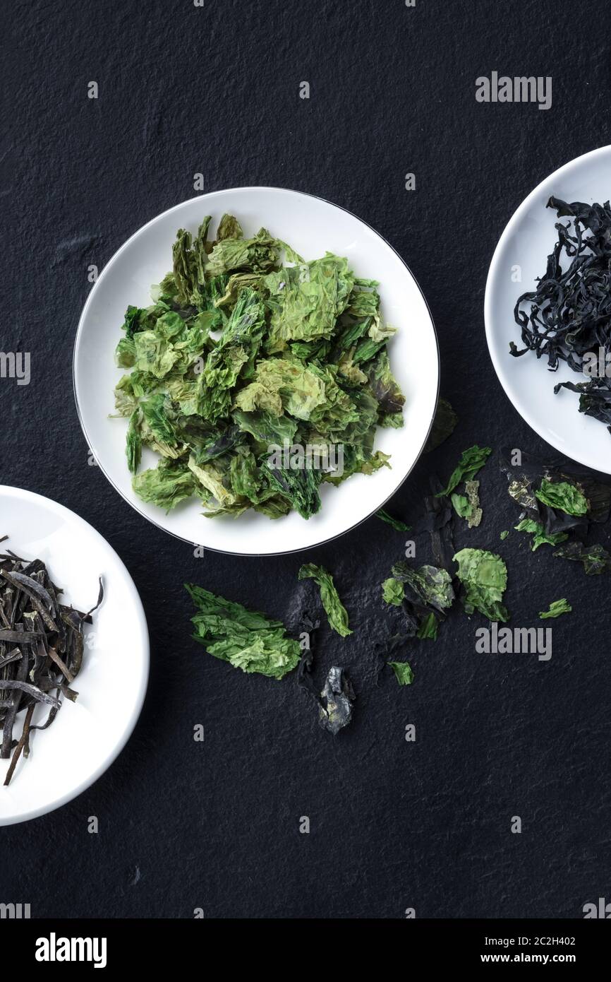 Various dry seaweed, sea vegetables, shot from the top on a dark ...