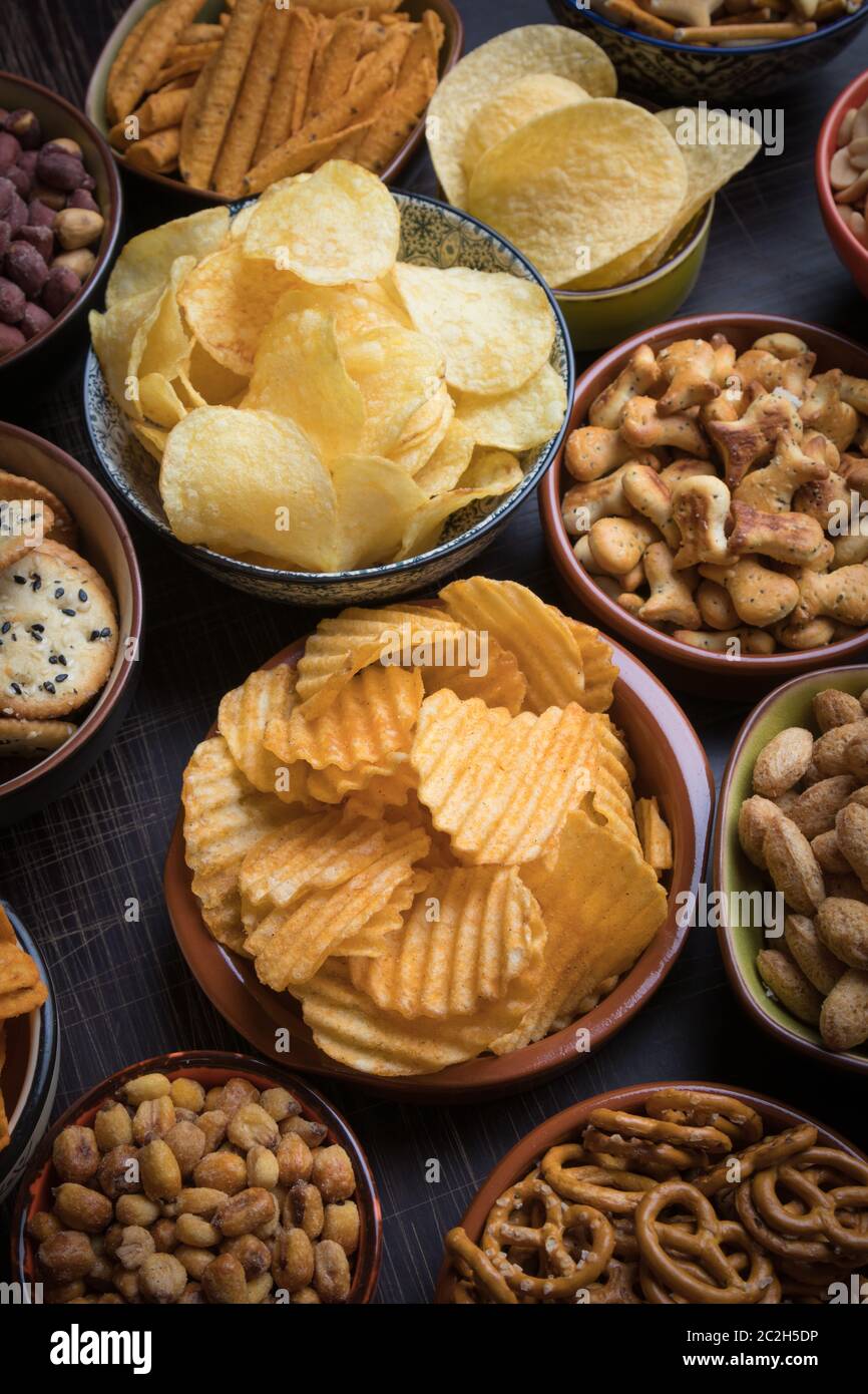 Salty snacks served as party food in ceramic bowls Stock Photo - Alamy