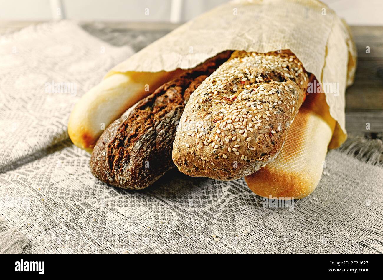 Different types of home-baked bread are on the table. Food background ...