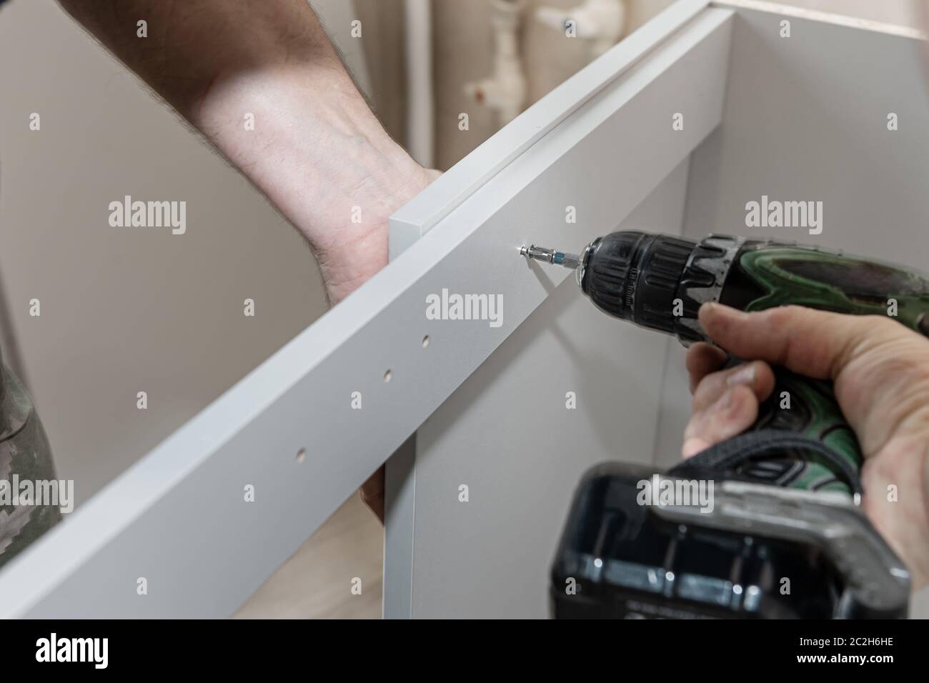 master builds a furniture Cabinet. Mounting for furniture panels ...
