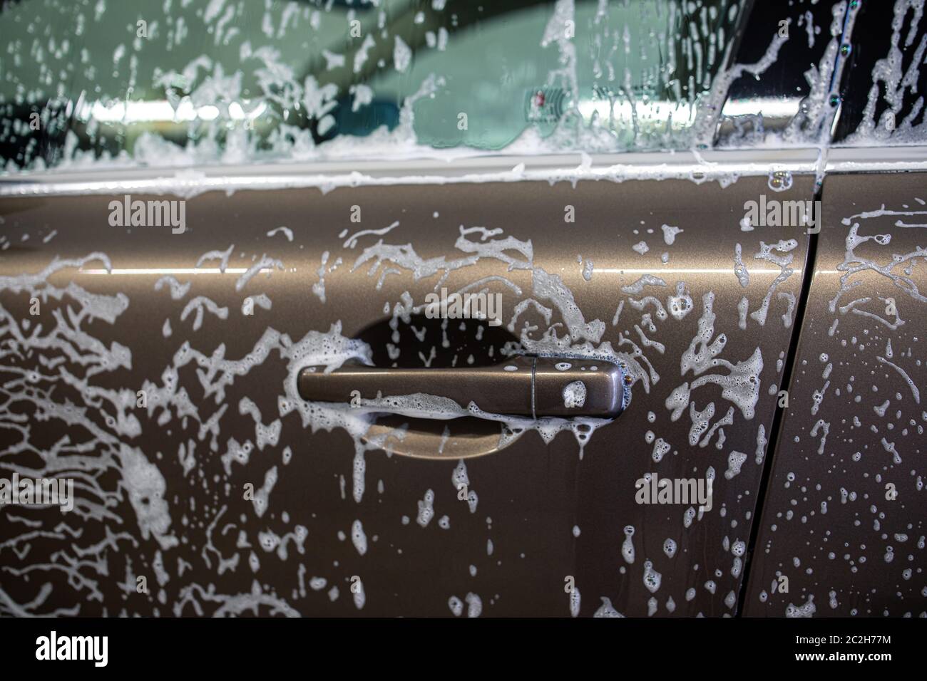 Car in a carwash covered with shampoo Stock Photo - Alamy