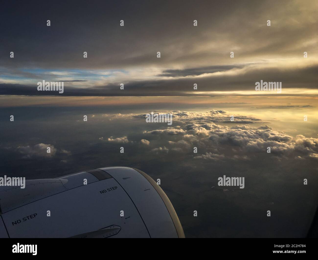 View of the sky and clouds from the airplane porthole. jet engine ...