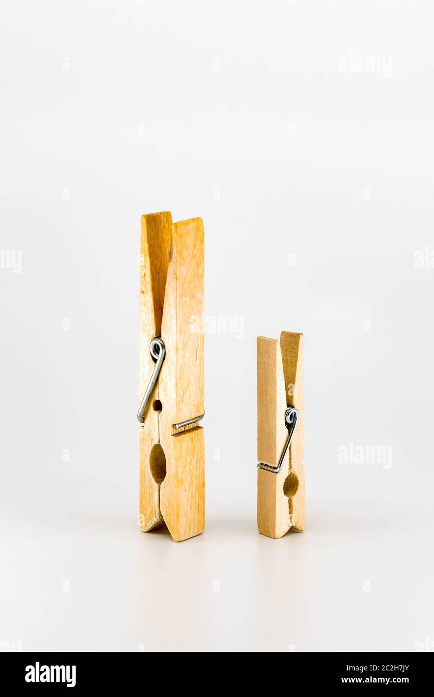 One large wooden clothes peg and one small wooden clothes peg isolated ...