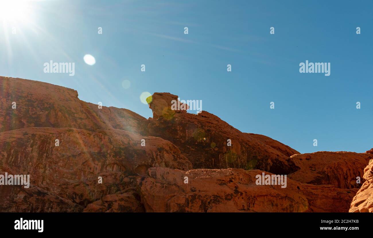 Sun flare over red rocks Stock Photo - Alamy