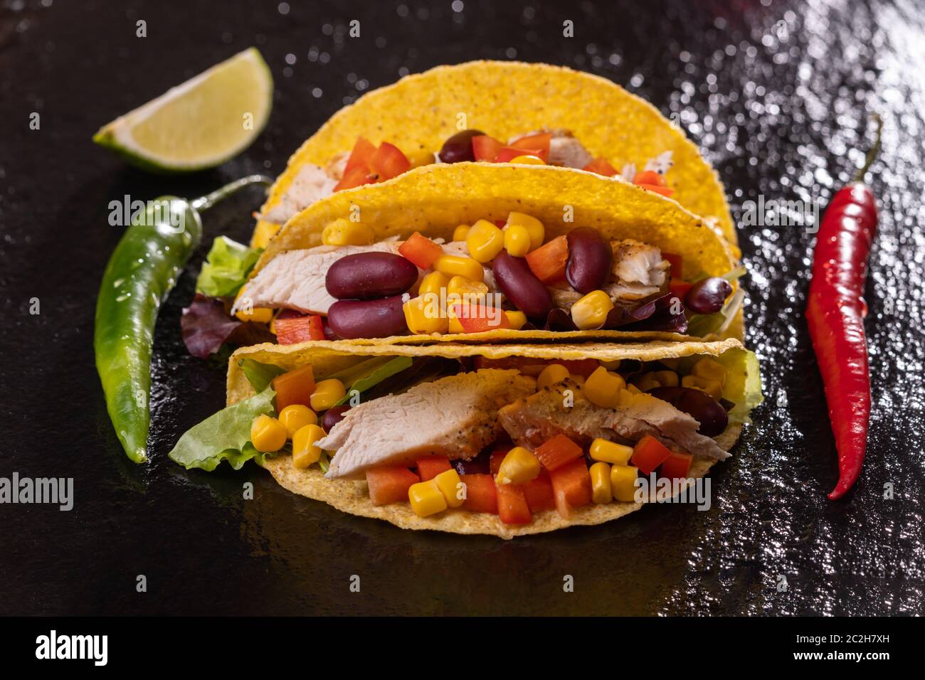 three mexican tacos on slate Stock Photo - Alamy