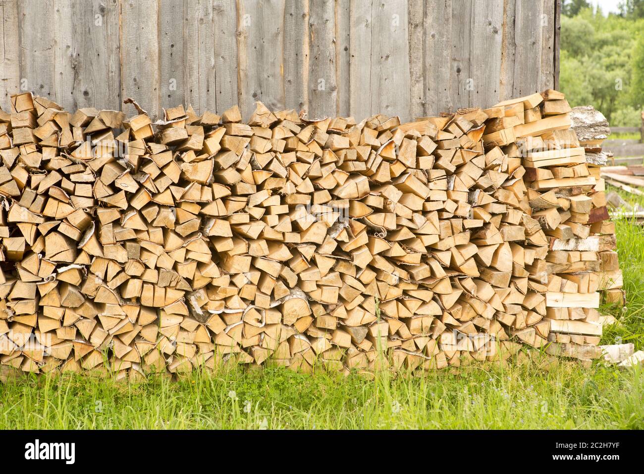 Woodpile - stack of wood. Firewood, sawn trees Stock Photo - Alamy