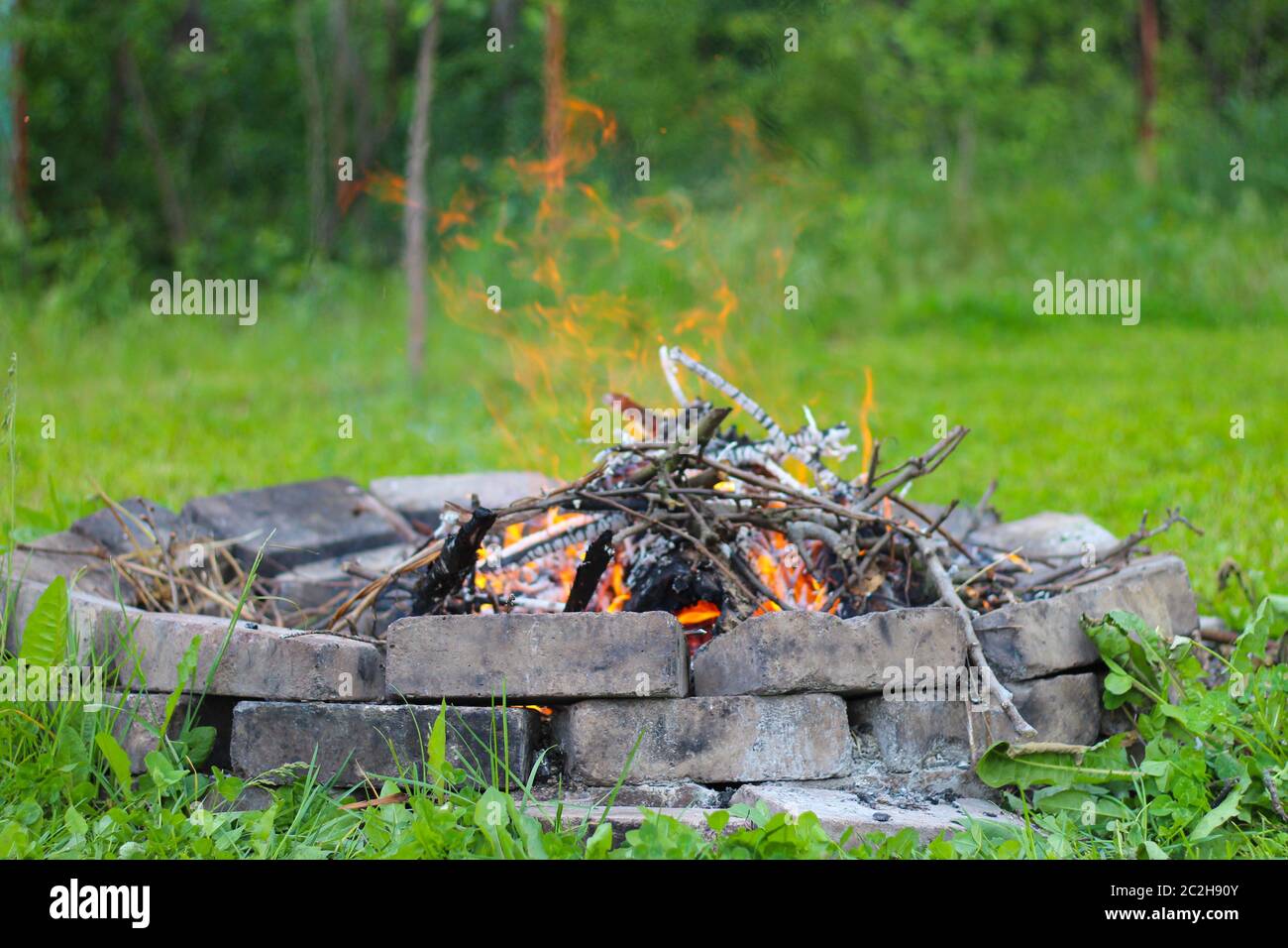 Refractory brick fireplace in focus and blurry bonfire in the ...