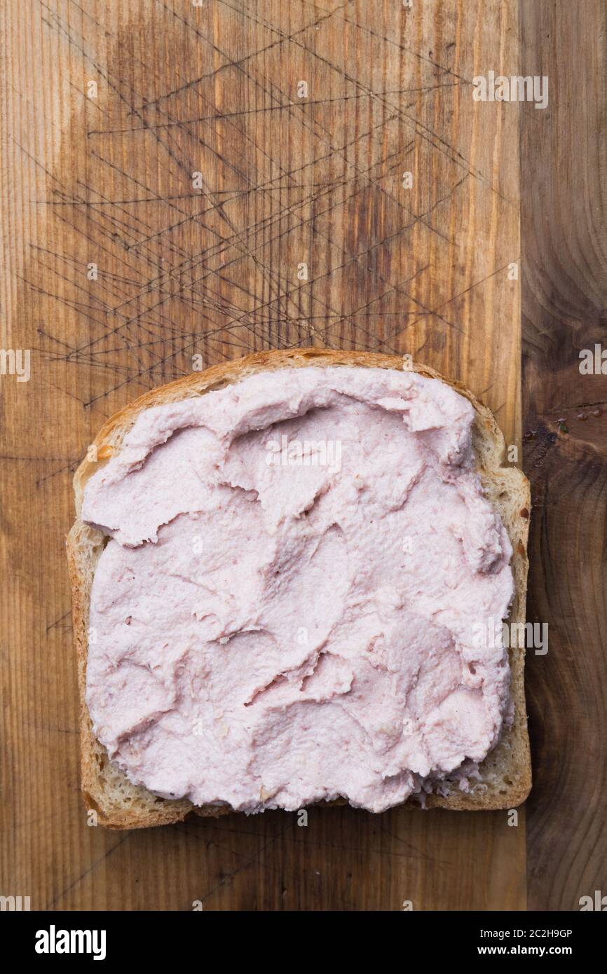 Slice of toast bread with meat pate spread shot from above Stock Photo ...